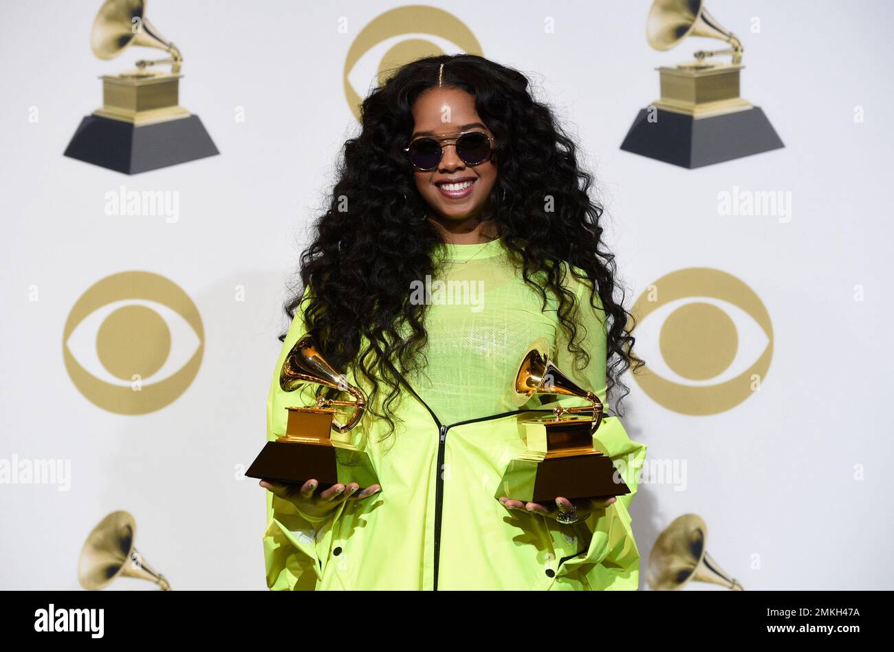 H.E.R. poses in the press room with the awards for best R&B album for ...