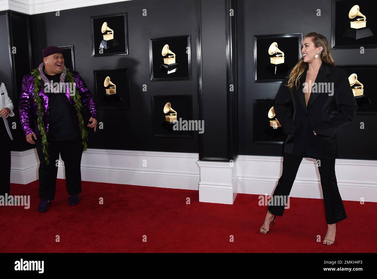 Kalani Pe'a, left, and Miley Cyrus arrive at the 61st annual Grammy ...