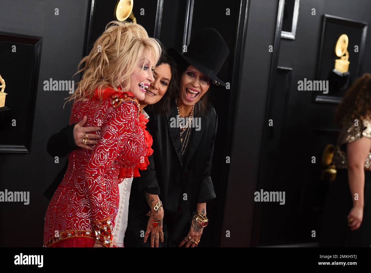 Dolly Parton, from left, Sara Gilbert, and Linda Perry arrive at the ...
