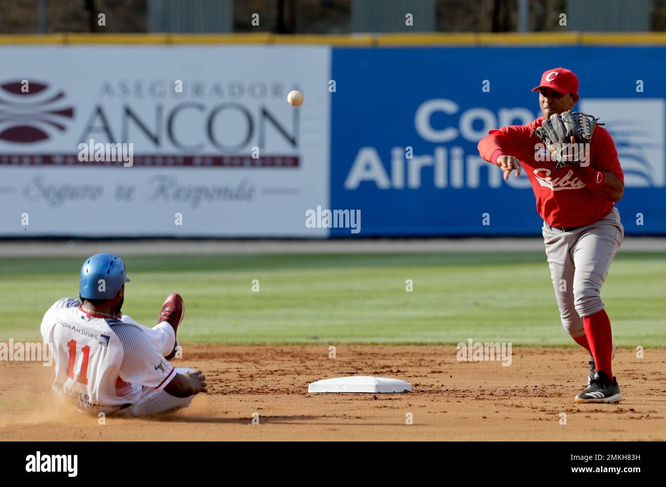 Elmer Reyes of Panama's Los Toros de Herrera, left, is out as second ...