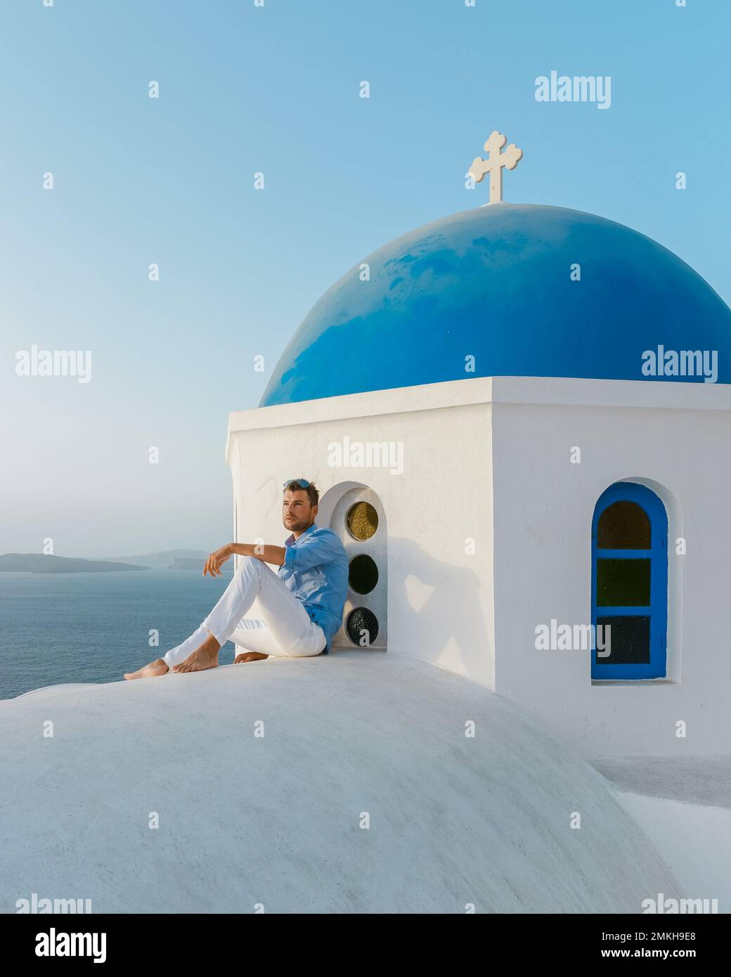 young men at Oia Santorini Greece on a sunny day during summer with ...