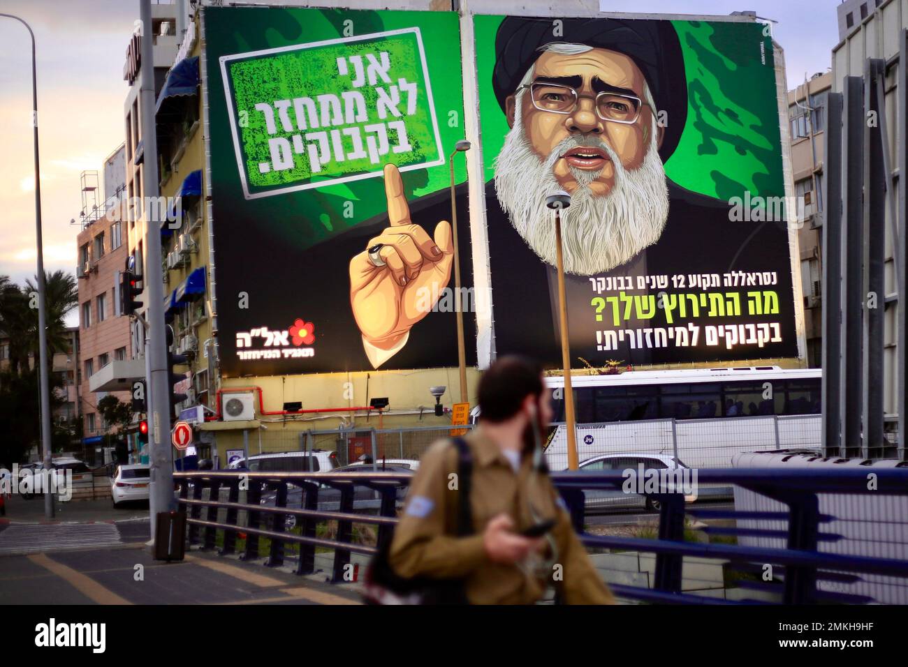 A billboard shows Hezbollah militant leader Hassan Nasrallah above a ...