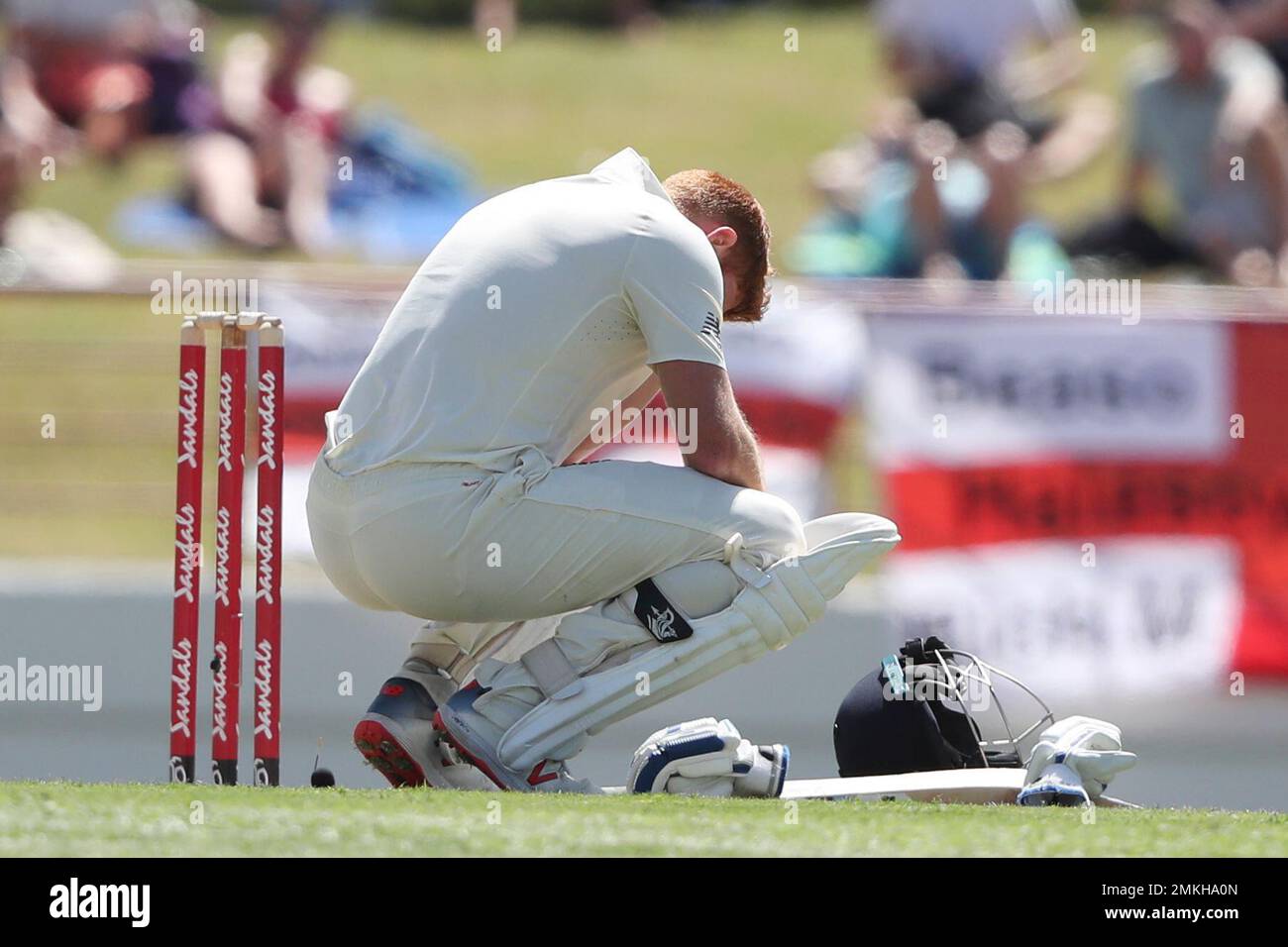England's Jonny Bairstow crouches after being hit by a delivery during ...