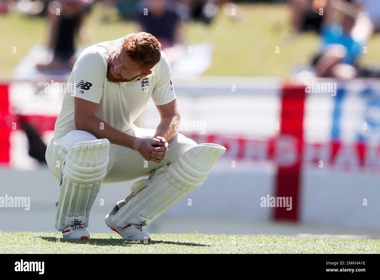 England's Jonny Bairstow crouches after being hit by a delivery during ...