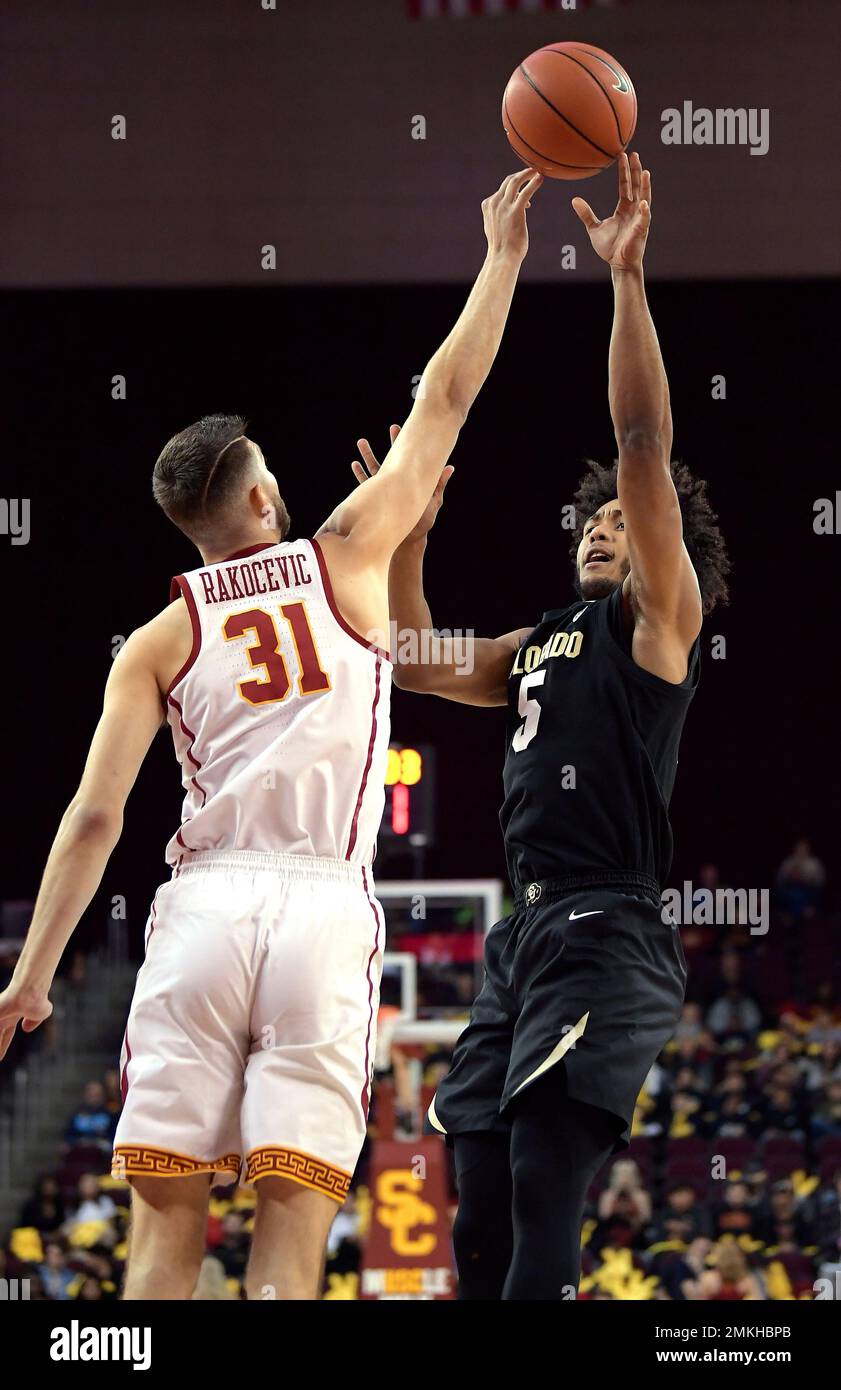 Colorado guard D'Shawn Schwartz, right, shoots as Southern California ...