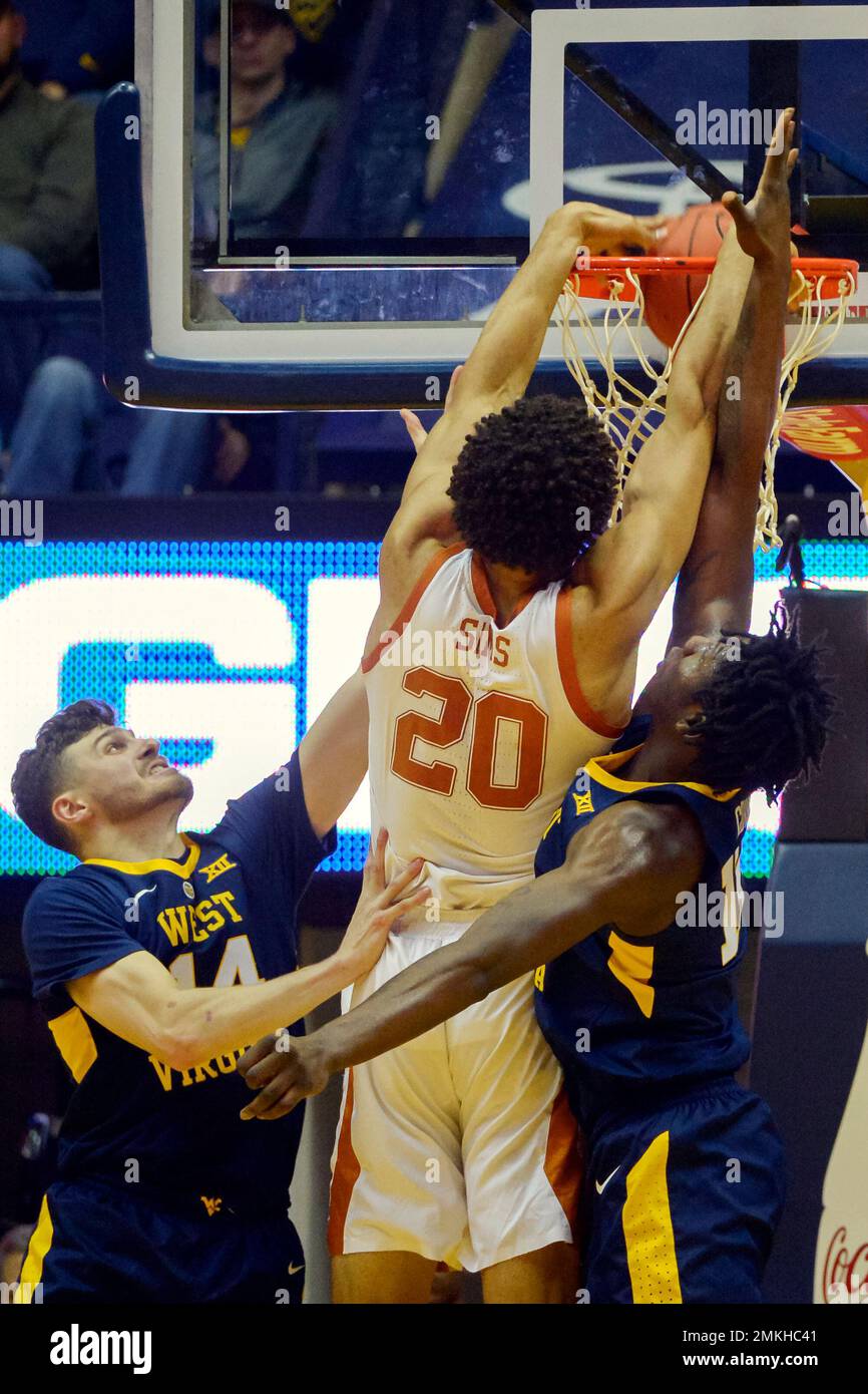 West Virginia guard Chase Harler (14) and forward Andrew Gordon (12 ...
