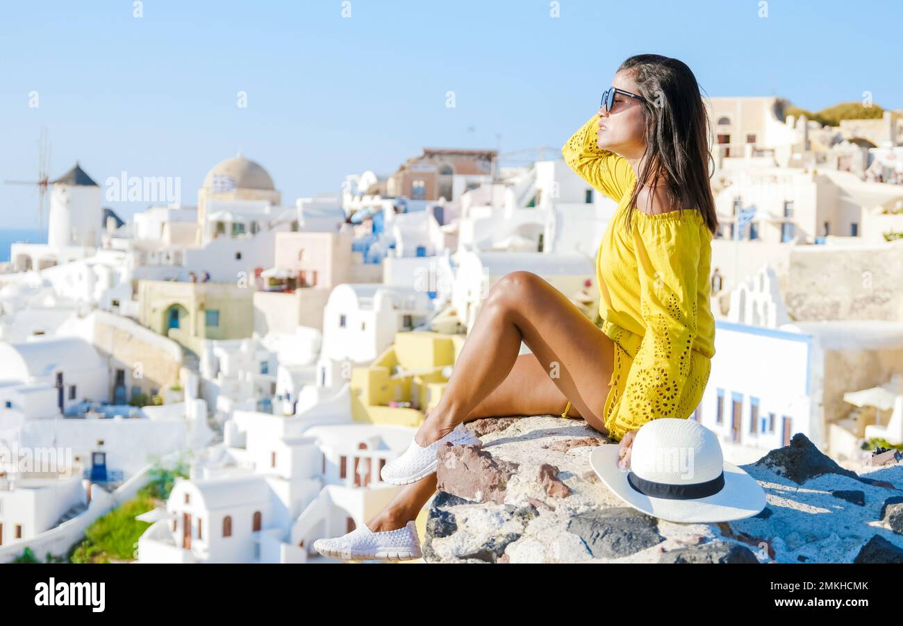 Asian woman visit Oia Santorini Greece on a sunny day during summer ...