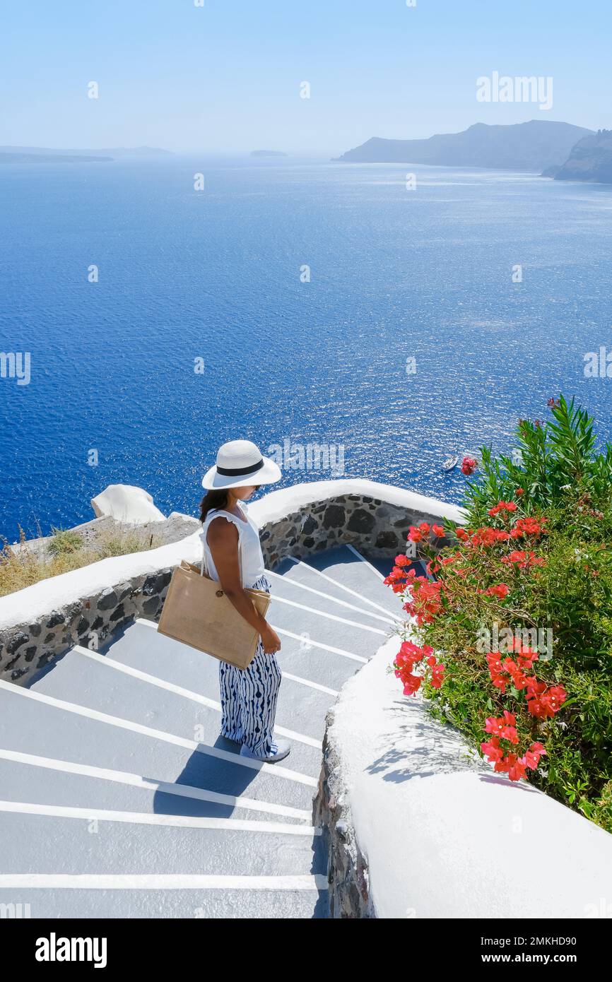 Asian woman visit Oia Santorini Greece on a sunny day during summer ...