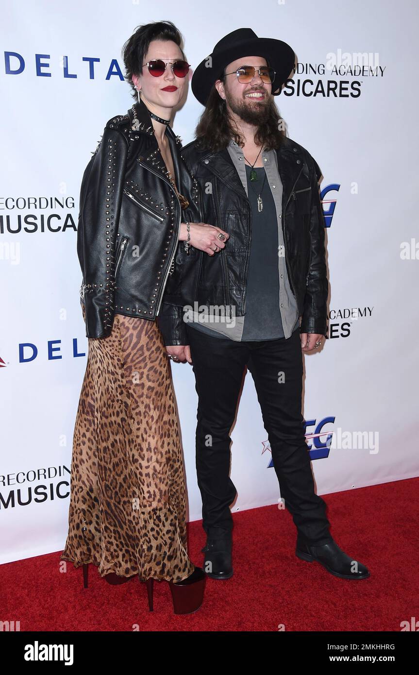Lzzy Hale, left, and Joe Hottinger, of Halestorm, arrive at MusiCares ...