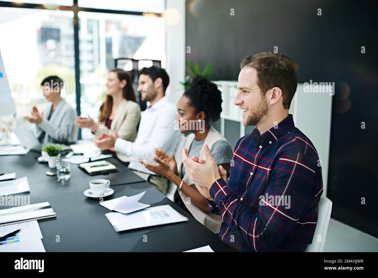 Celebrating exceptional work. a group of businesspeople applauding ...