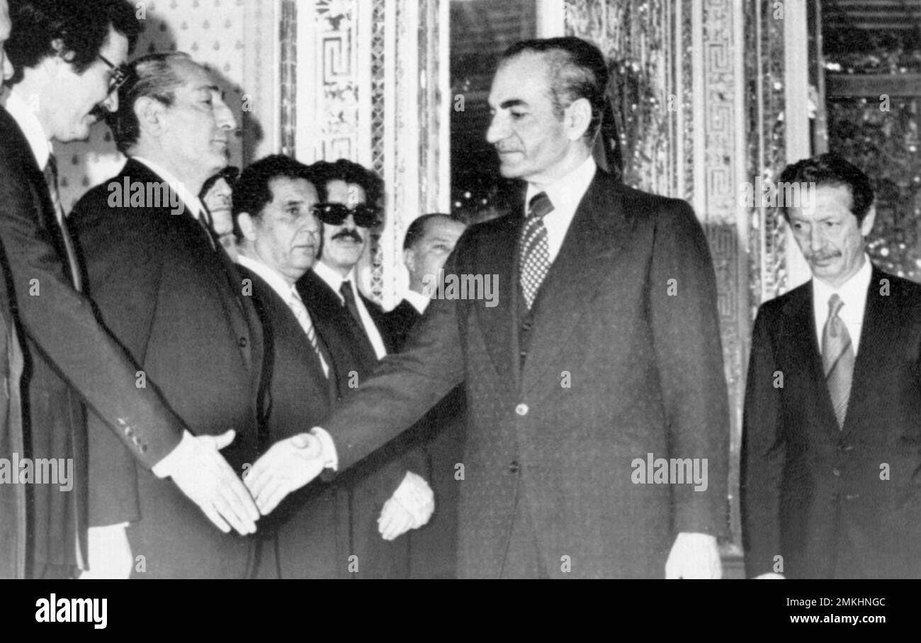 Shah Mohammad Reza Pahlavi shakes hands with the ministers of the new ...