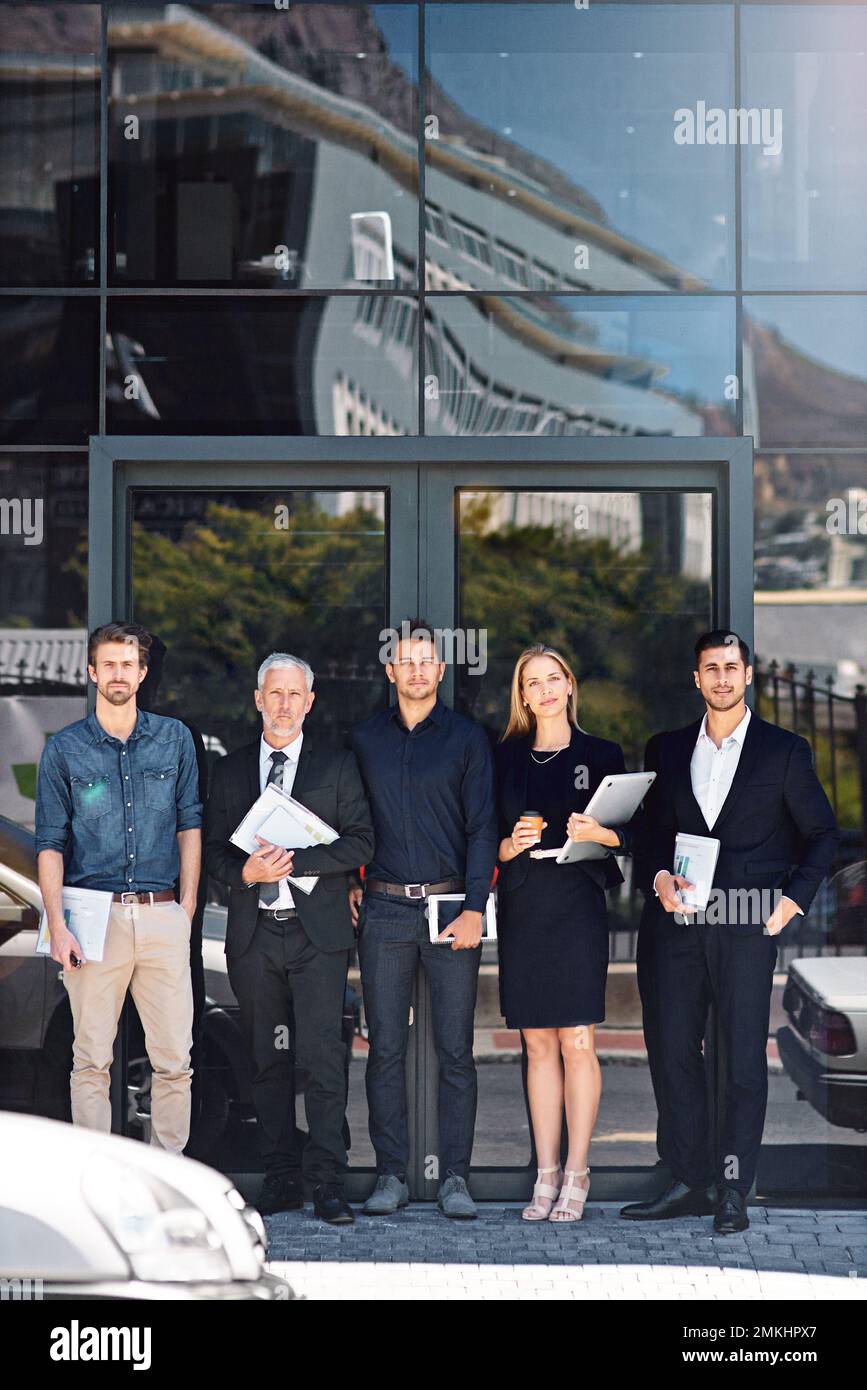 Waiting to welcome you in. Portrait of a team of focused professionals ...