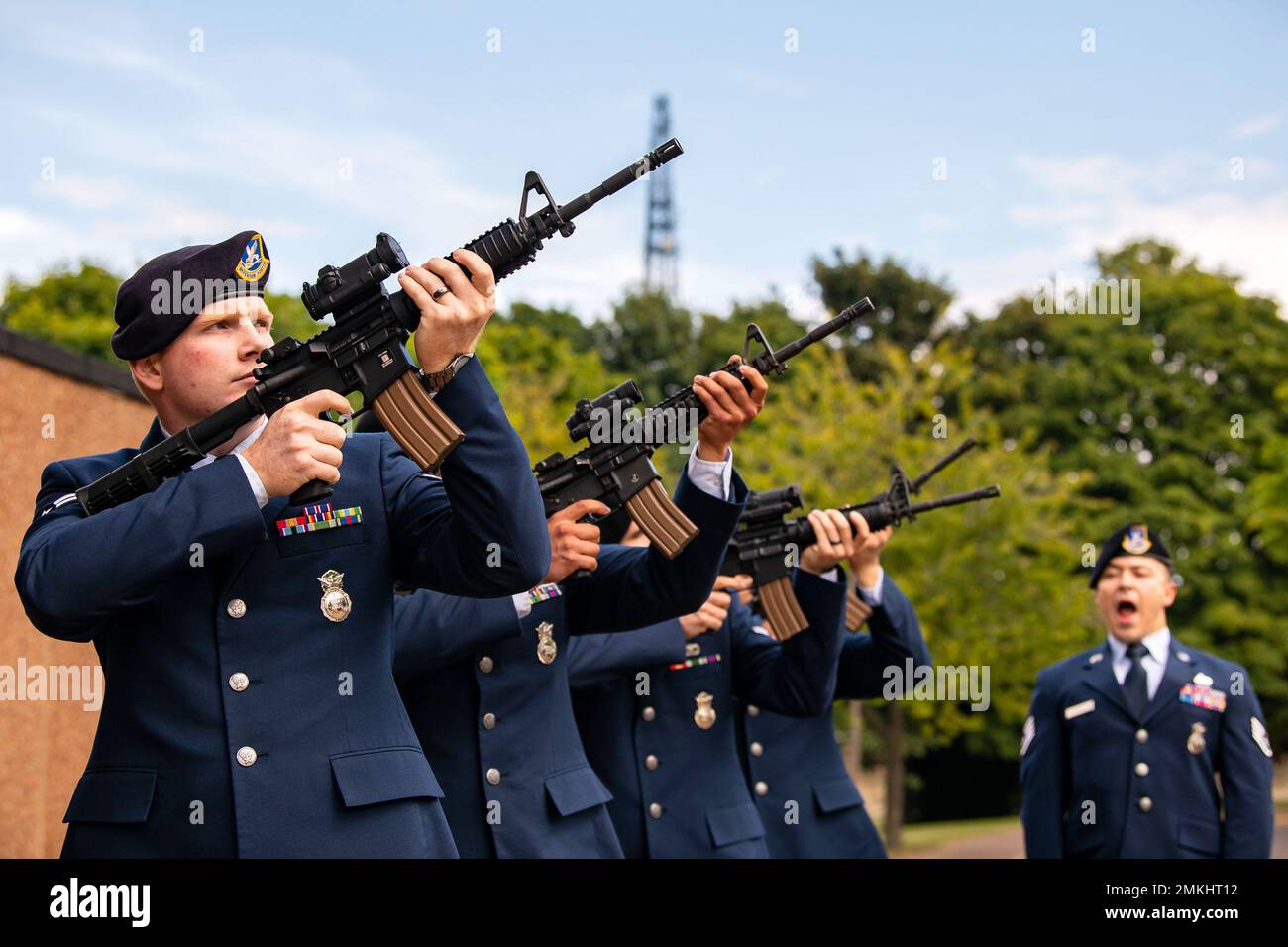 Airmen from the 422d Security Forces Squadron fire a volley salute ...