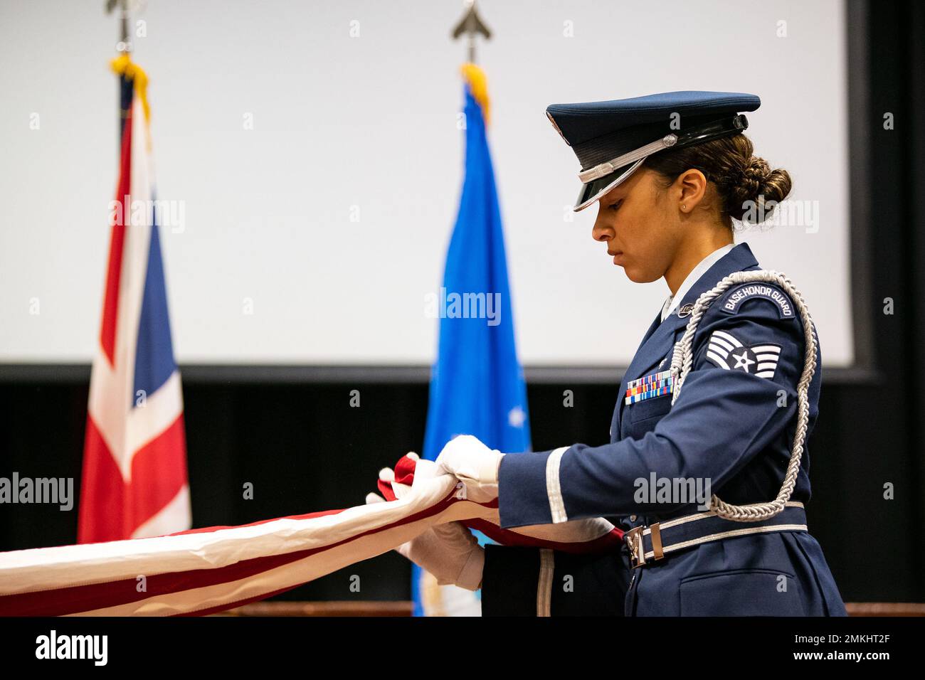 An Airman from the 422d Air Base Group honor guard, folds a flag during ...