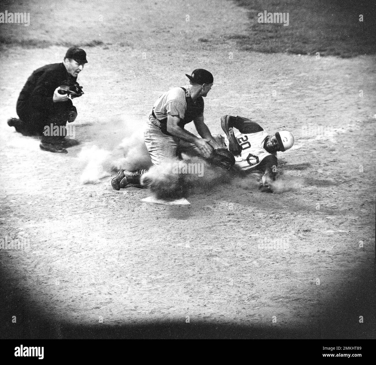 Cincinnati Reds Frankie Robinson slides into home plate as he is ...