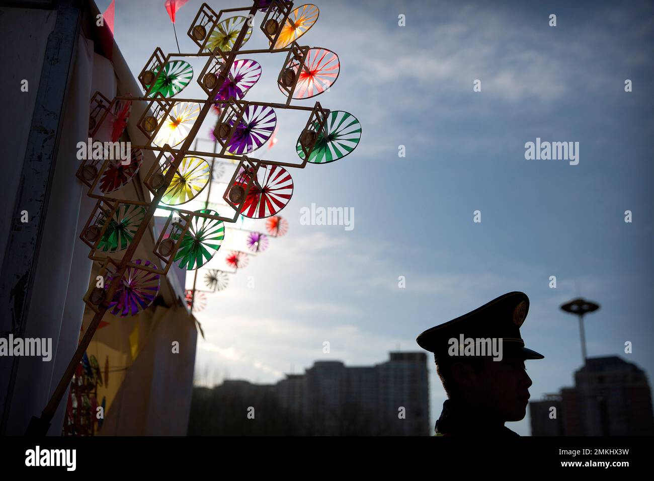 A paramilitary policeman stands on guard near a shop selling pinwheel ...