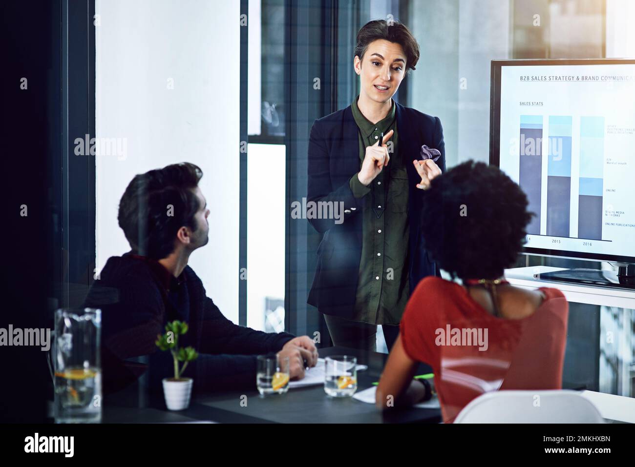 Talking over the main points. a young businesswoman giving a ...