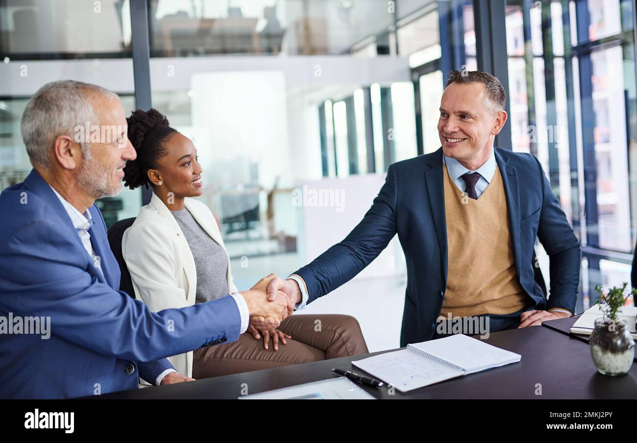 Making all the right connections. businesspeople shaking hands during a ...
