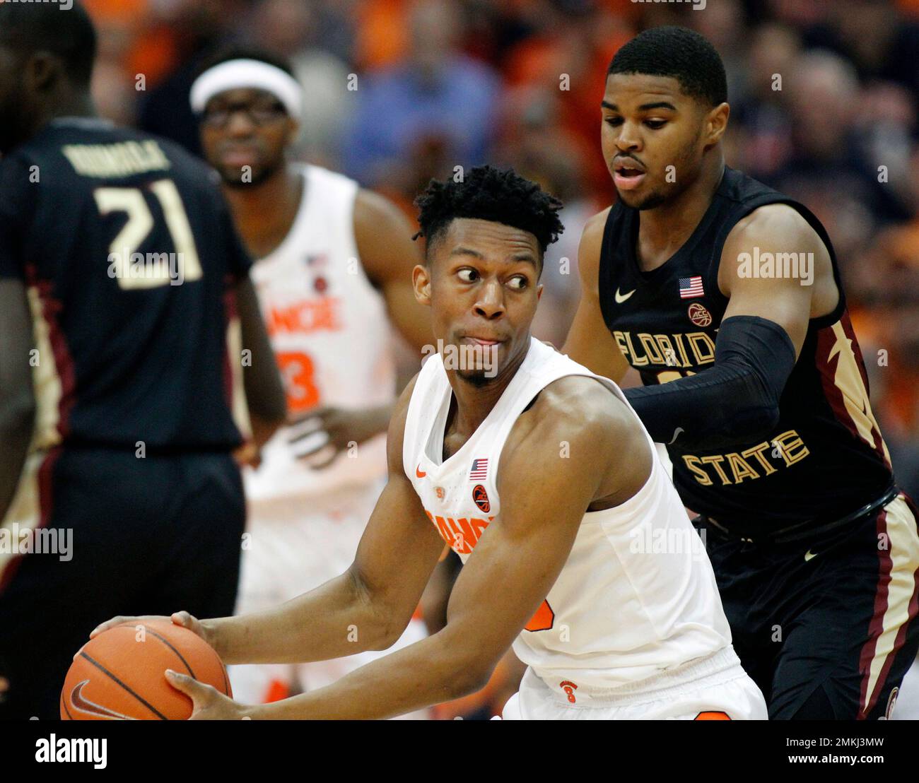Syracuse's Tyus Battle, right, looks to pass the ball while being ...