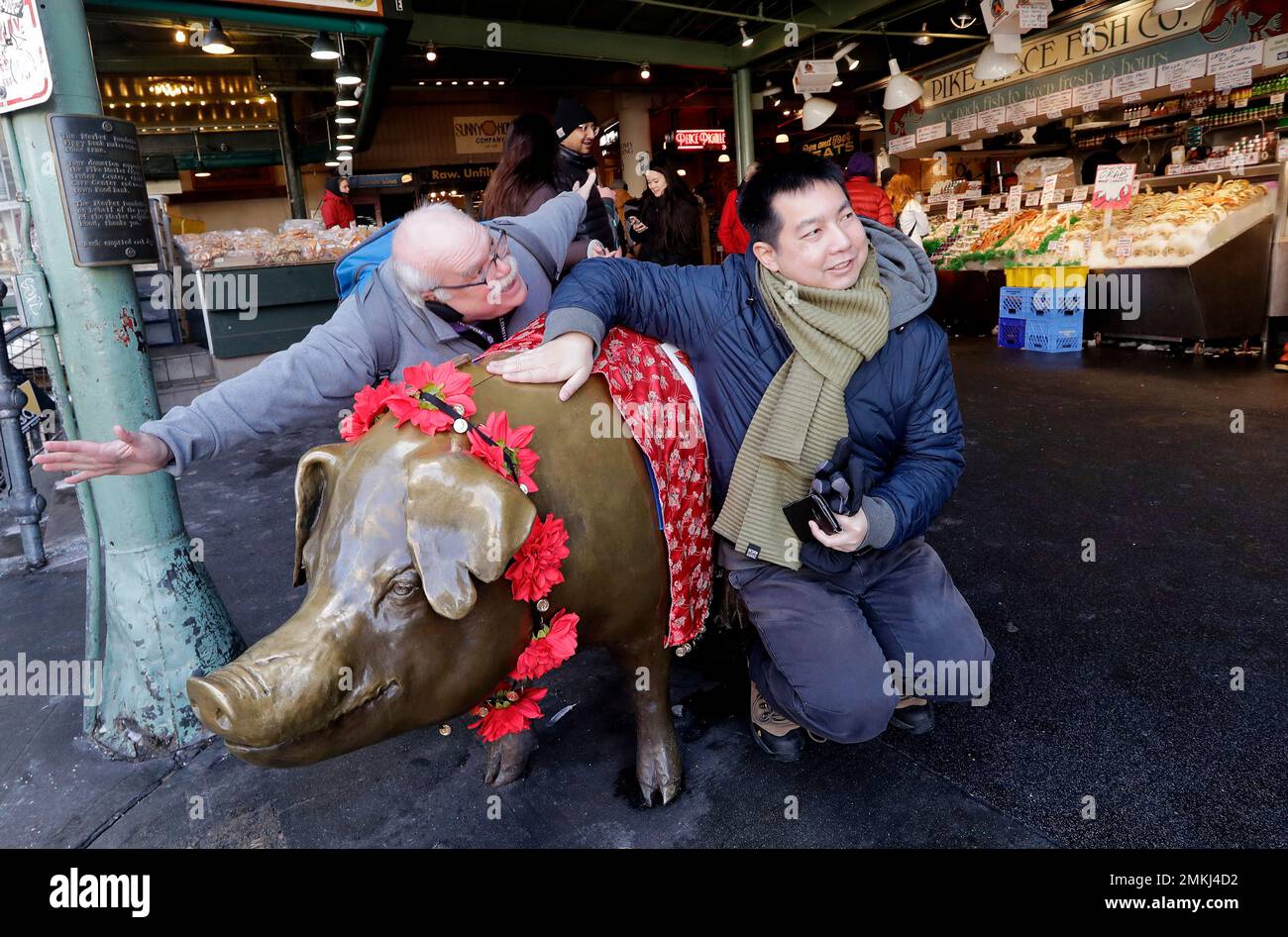 Tony Huang, right, of Taiwan, poses with giant piggy bank sculpture ...