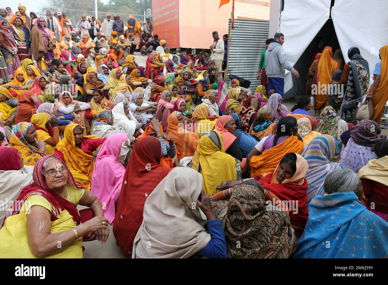 Hindu devotees participate in a community feast at Sangam, the ...