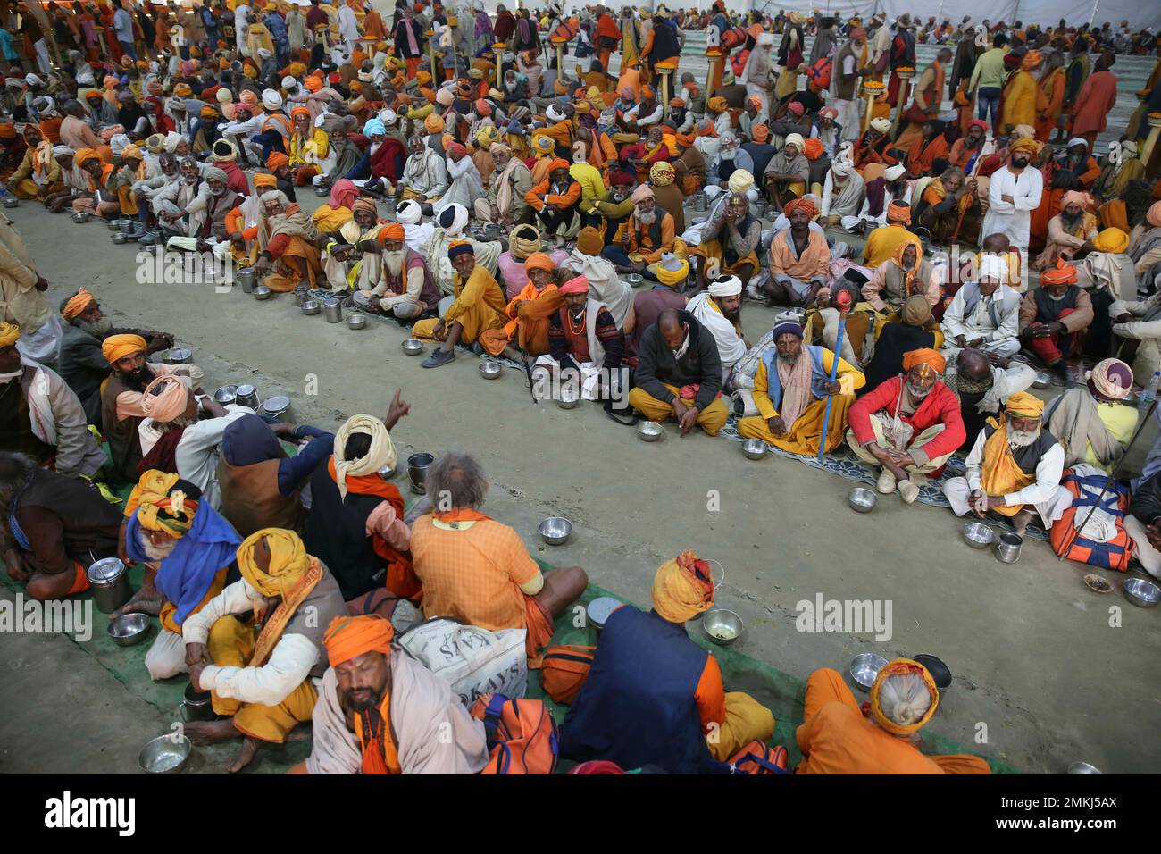 Hindu devotees participate in a community feast at Sangam, the ...