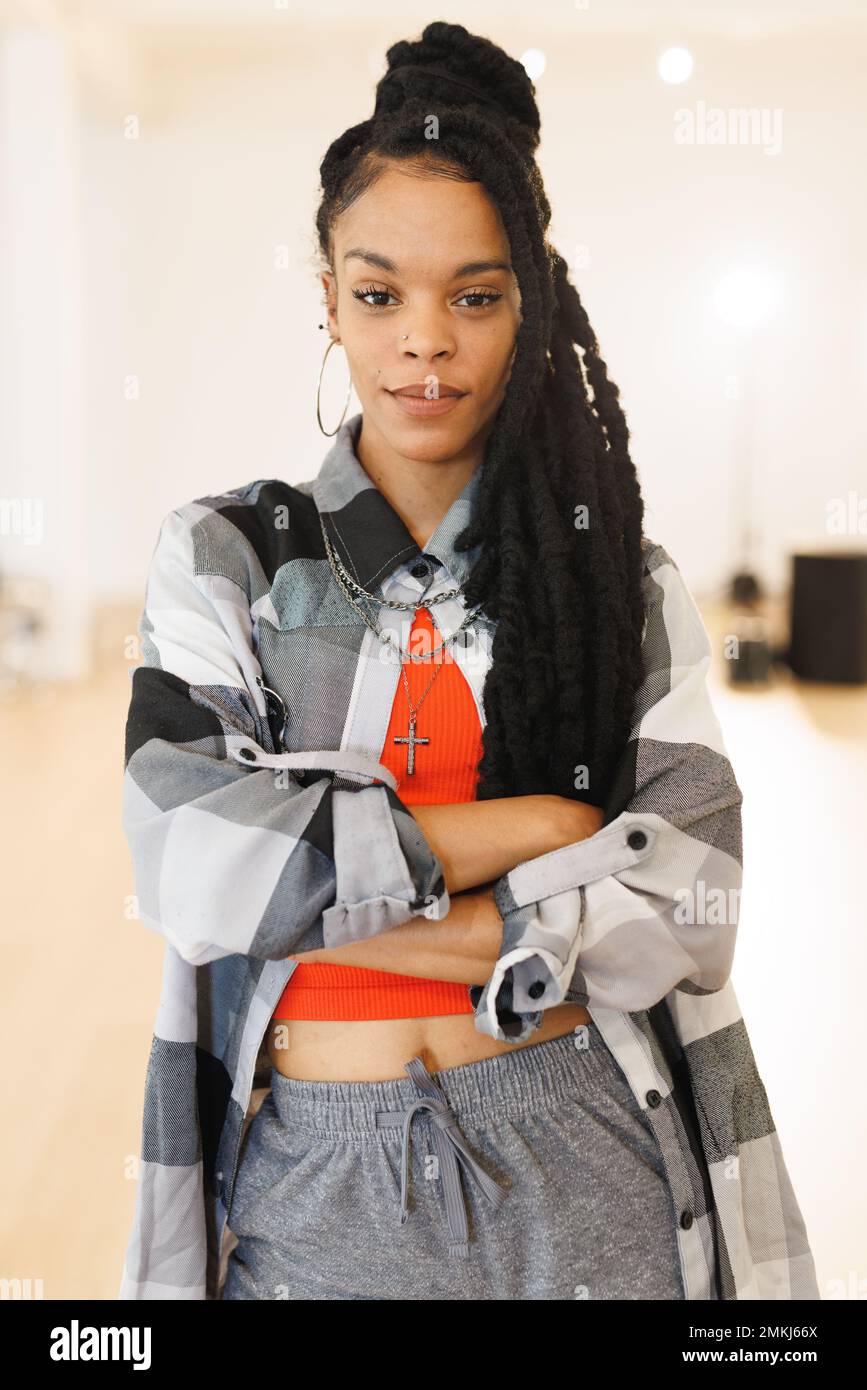 Vertical image of african american female hip hop dancer posing to ...