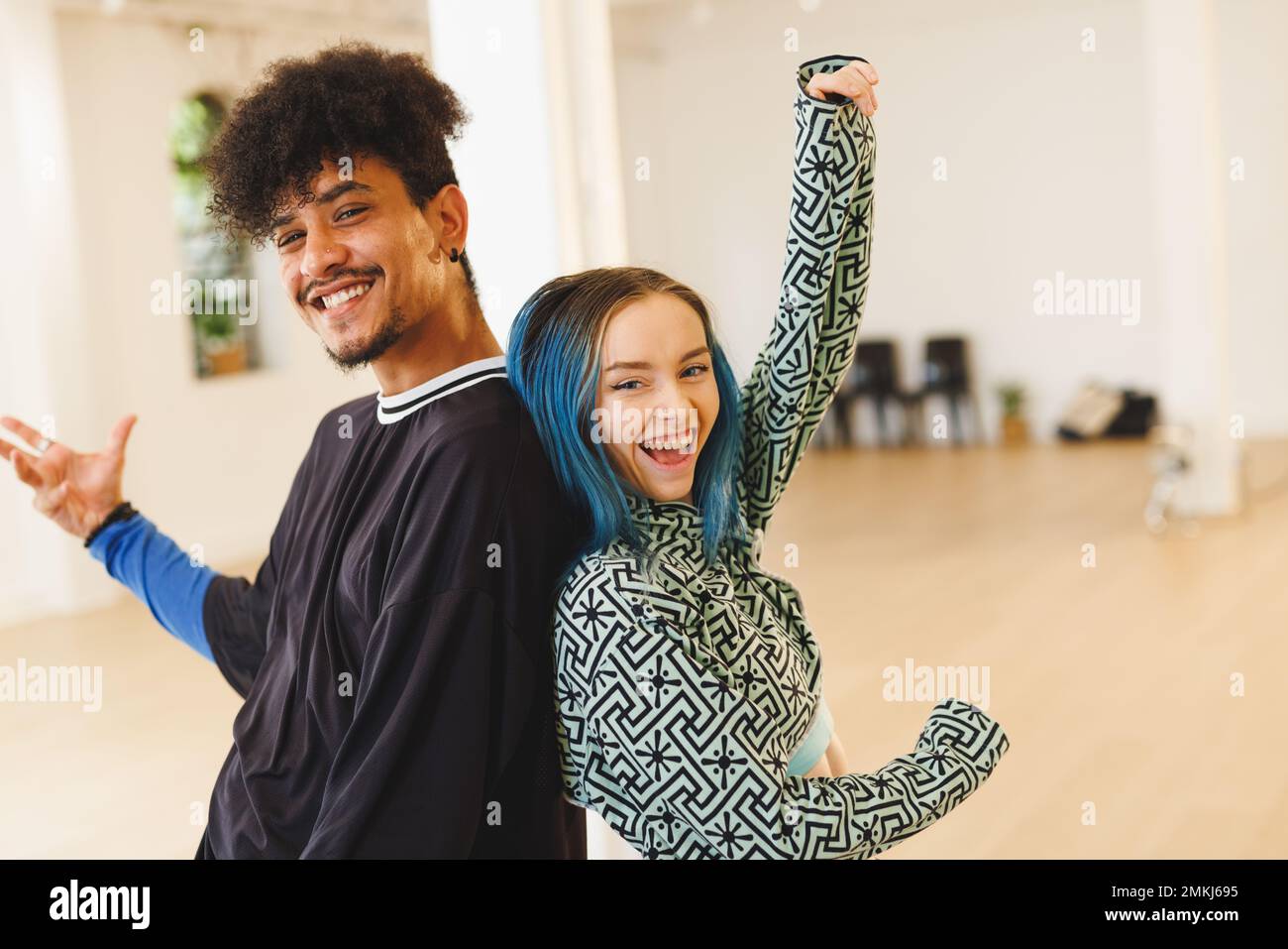 Image of happy diverse male and female hip hop dancers posing to camera ...