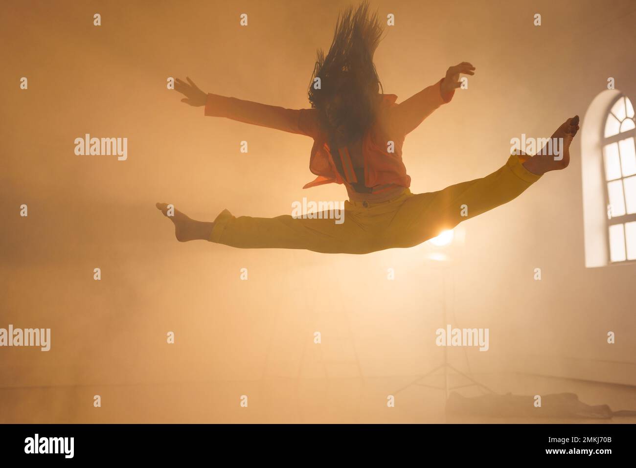 Image of biracial female modern dancer dancing in smoked interior ...