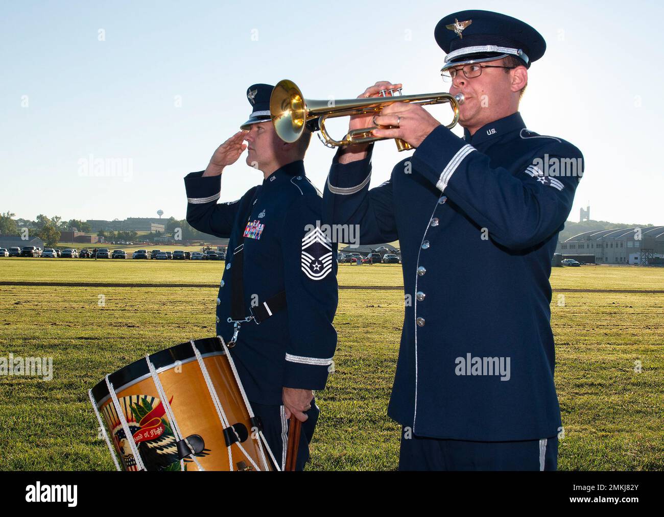 Senior Airman James Nufer plays taps as Chief Master Sgt. Stephen ...