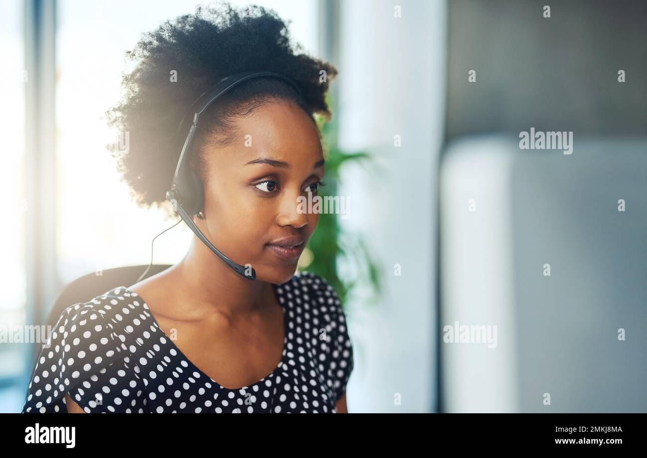 Please hold while I transfer your call. a support agent working in a ...