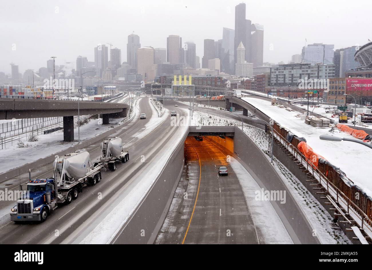 Traffic heads out of the brand new State Route 99 tunnel, left, and in ...