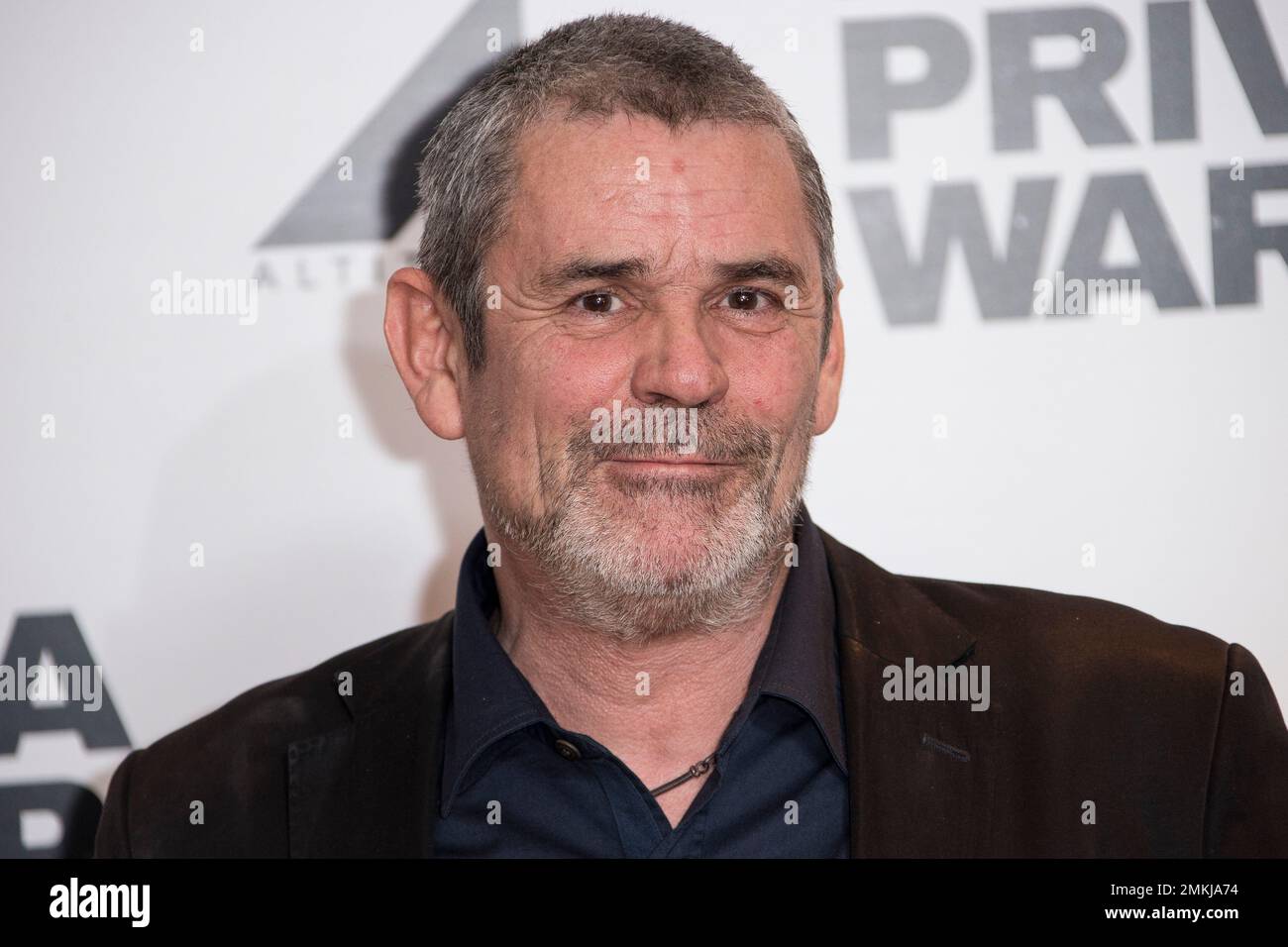 War photographer Paul Conroy poses for photographers upon arrival for a ...