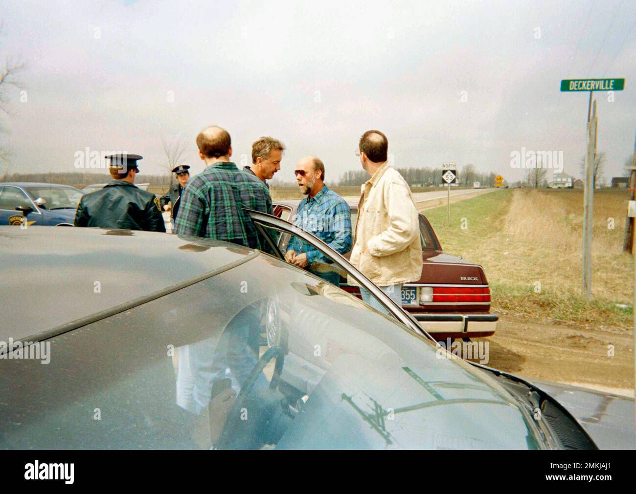 Law enforcement officials detain James Douglas Nichols, second from ...