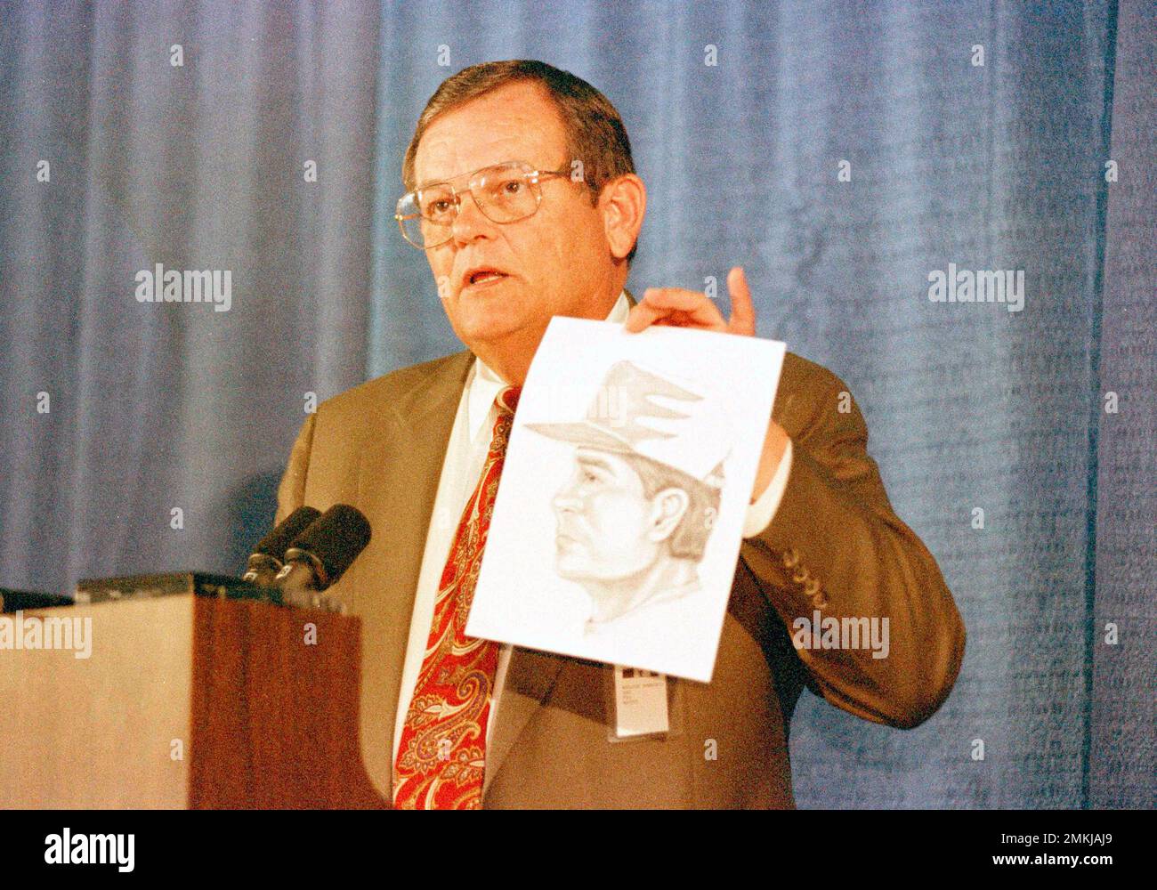 FBI Special Agent Weldon Kennedy holds up a new sketch of the man ...