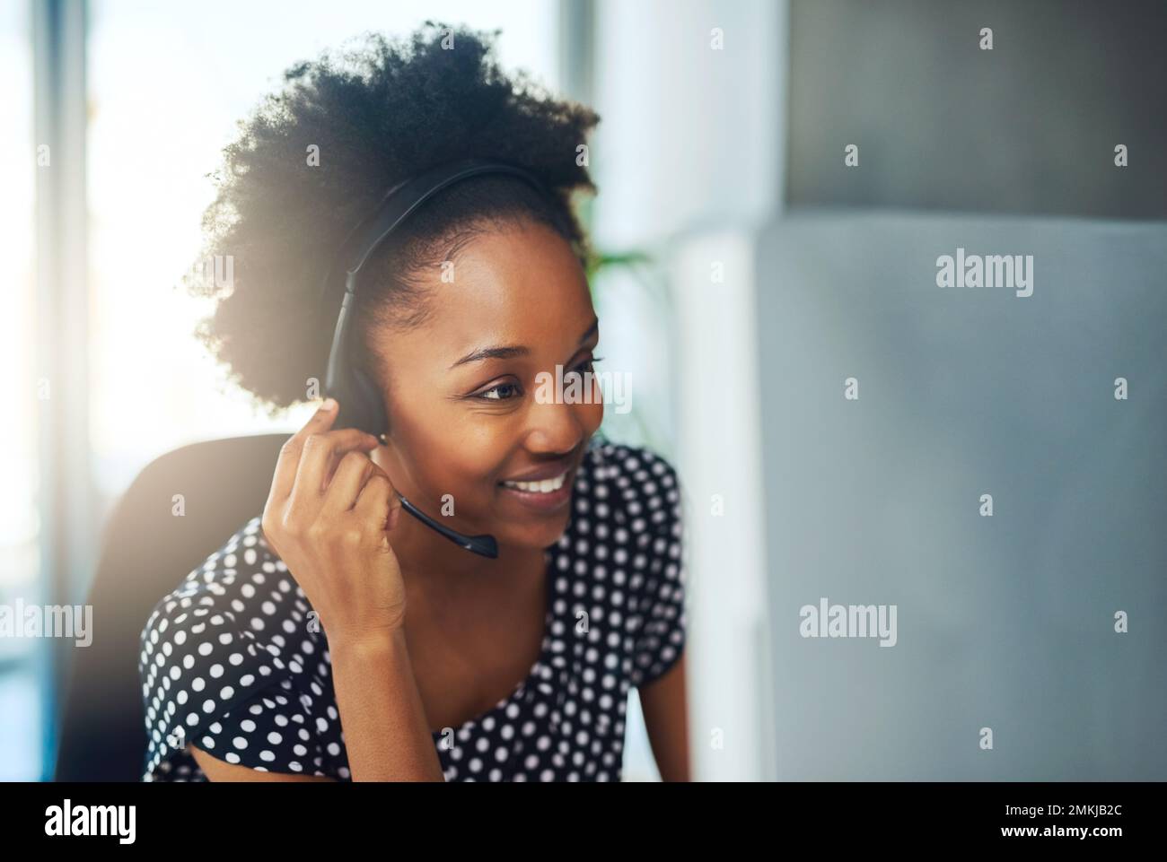 Thank you for calling our helpdesk. a support agent working in a modern ...
