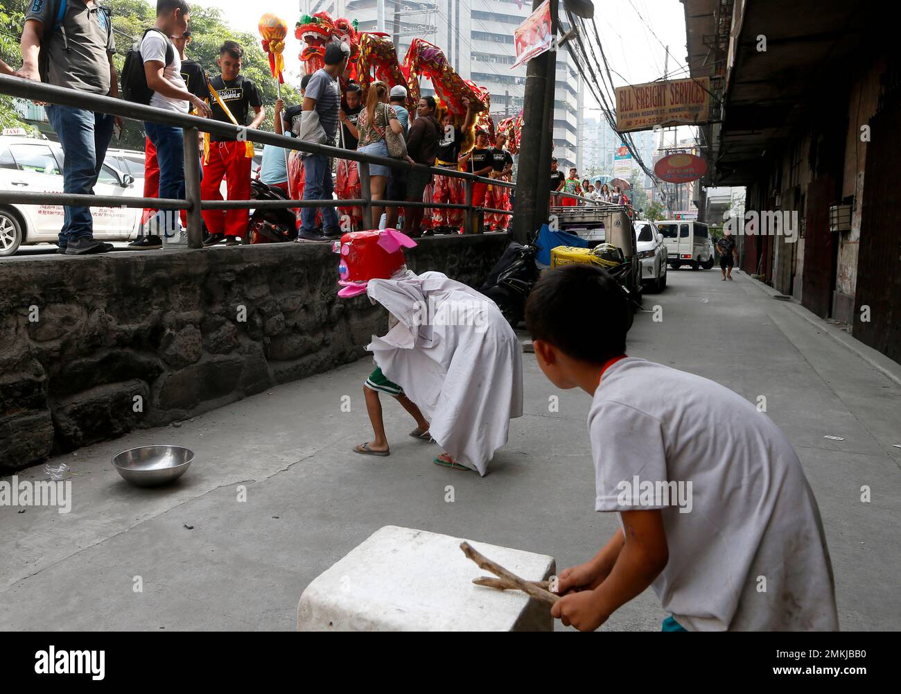 Enterprising Filipino children, use an improvised costume to perform ...