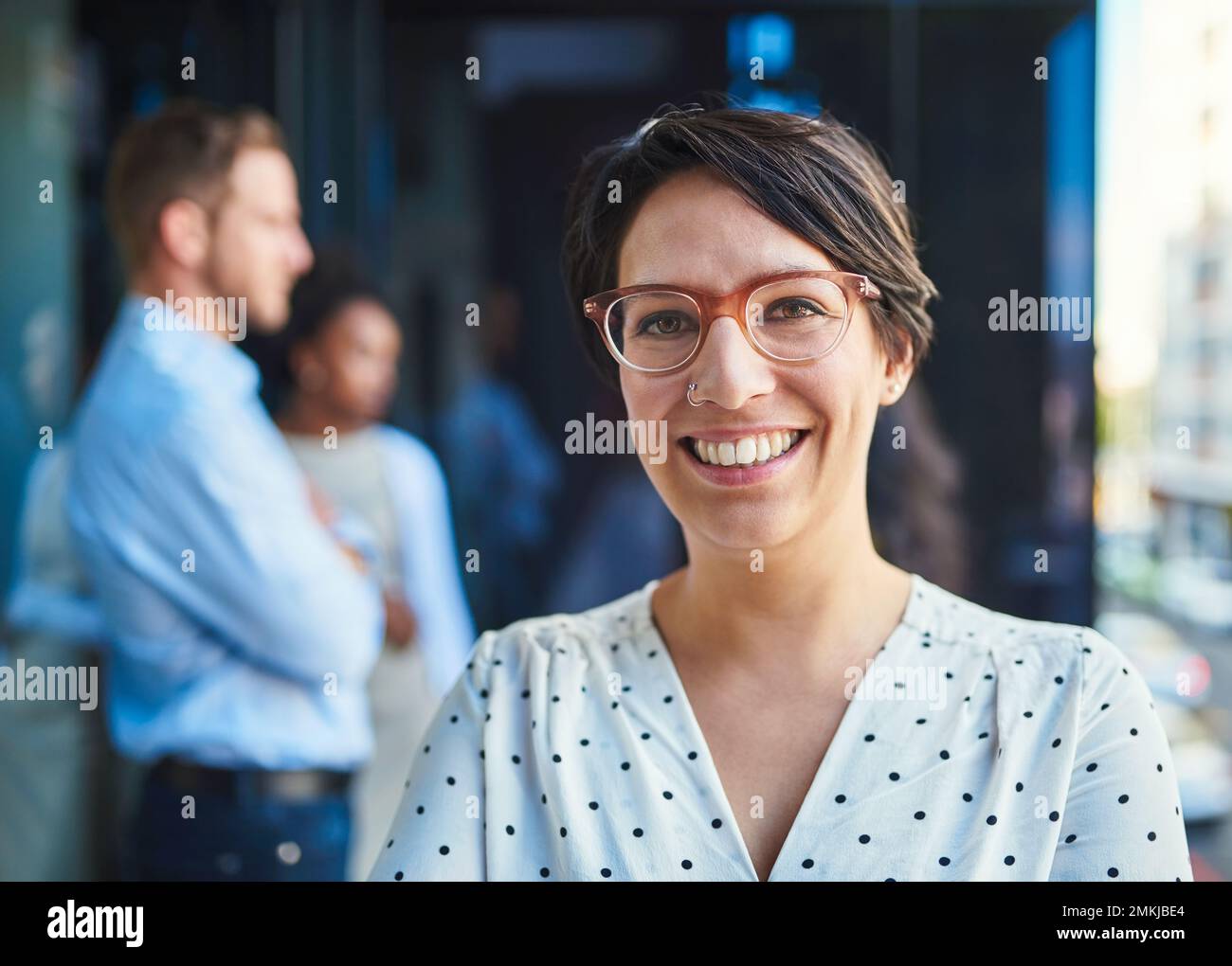 Hard work makes her happy. a young businesswoman standing on a balcony ...