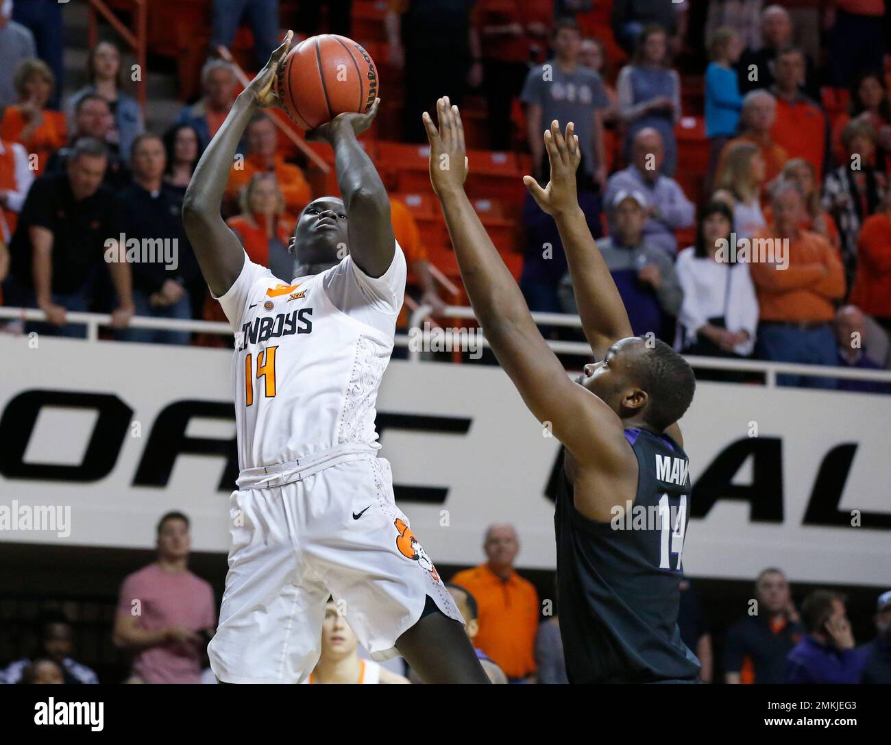 Oklahoma State forward Yor Anei (14) shoots in front of Kansas State ...
