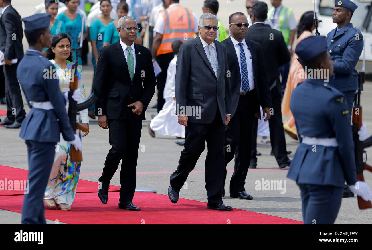Maldives' President Ibrahim Mohamed Solih, center, walks with his wife ...