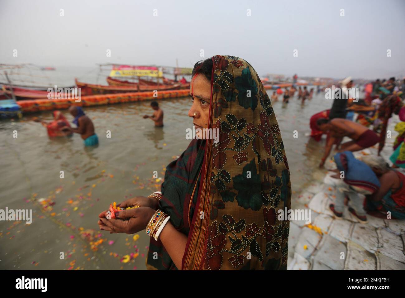 Indian Hindu pilgrims perform rituals on the eve of Mauni Amavasya, an ...