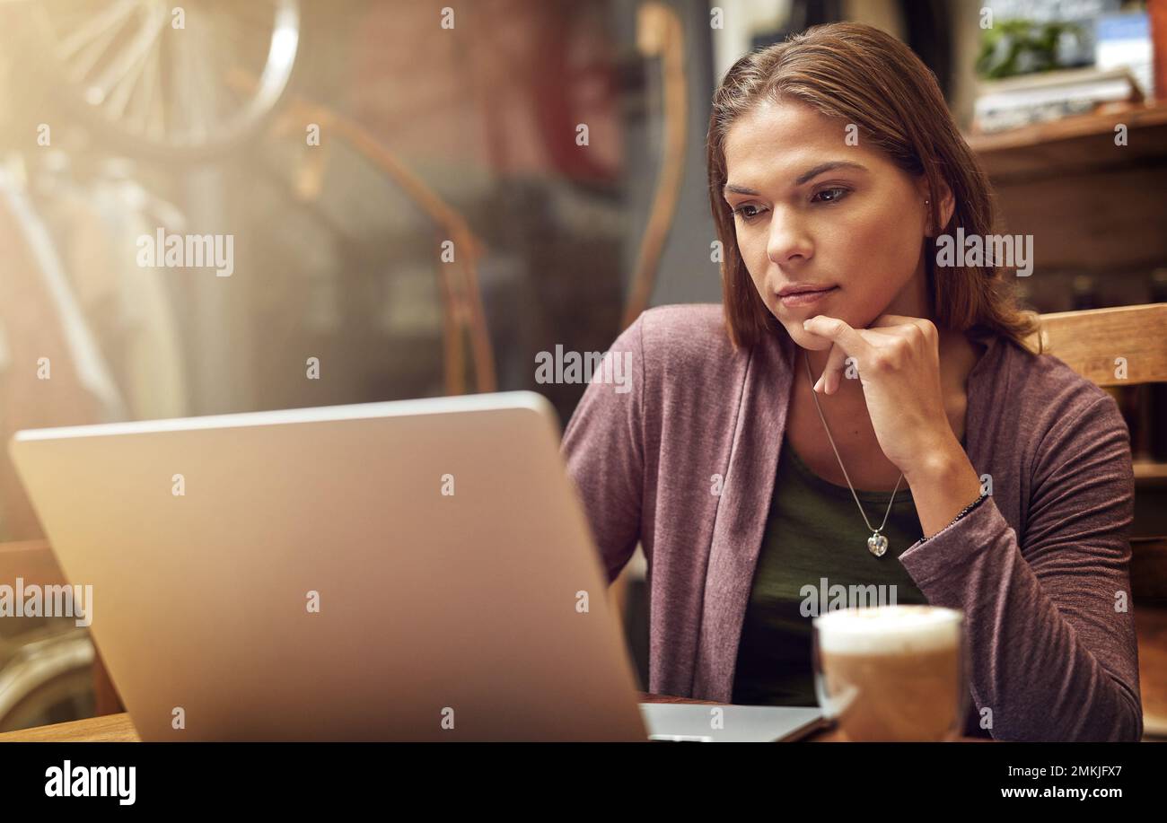 The perfect spot for a bit of easy browsing. a young woman using a ...