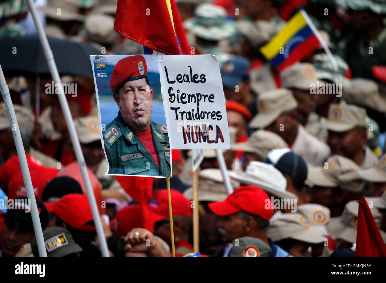 A government supporter holds a handmade poster depicting the late ...