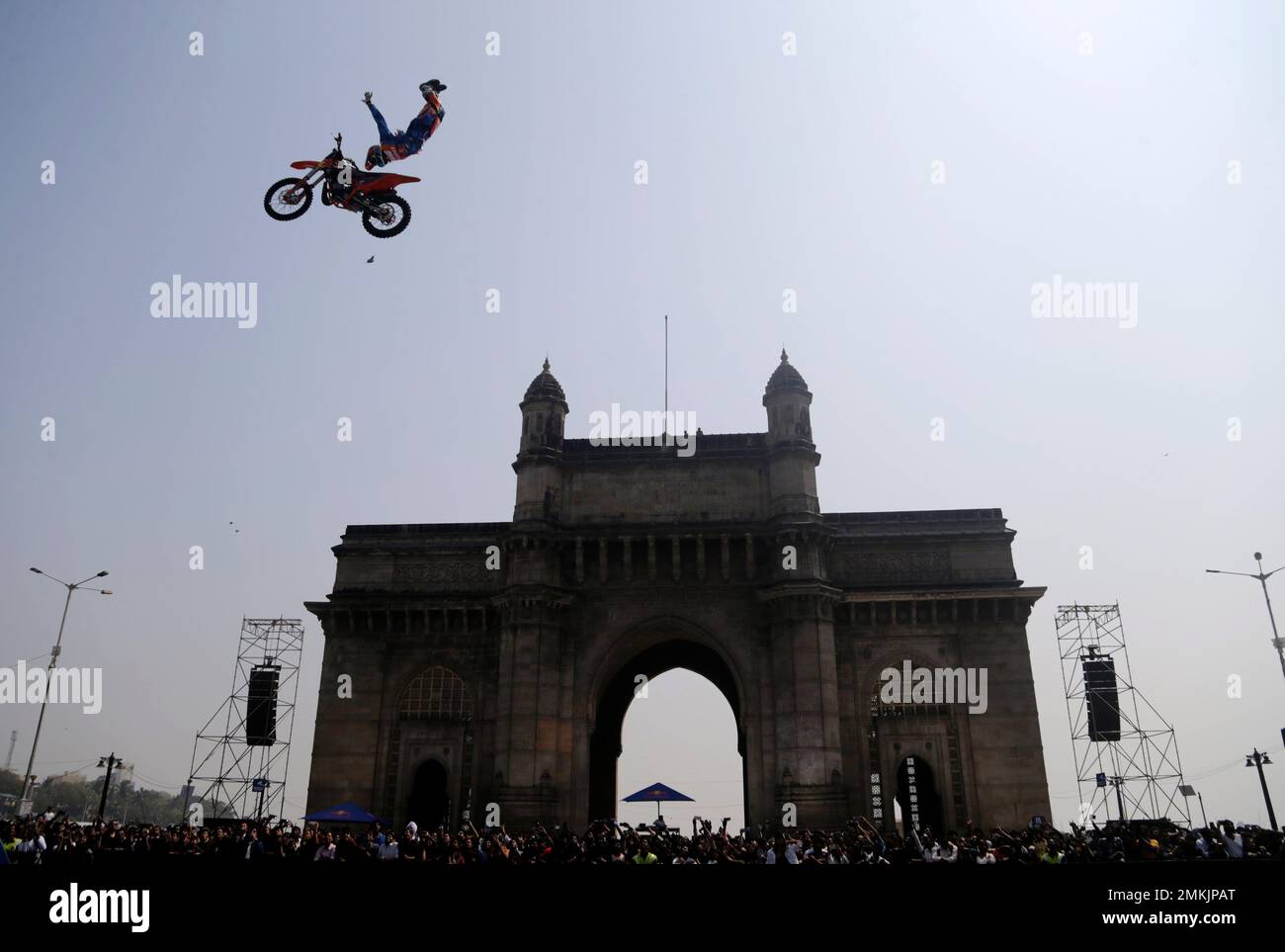 A biker performs stunts in front of the Gateway of India landmark ...