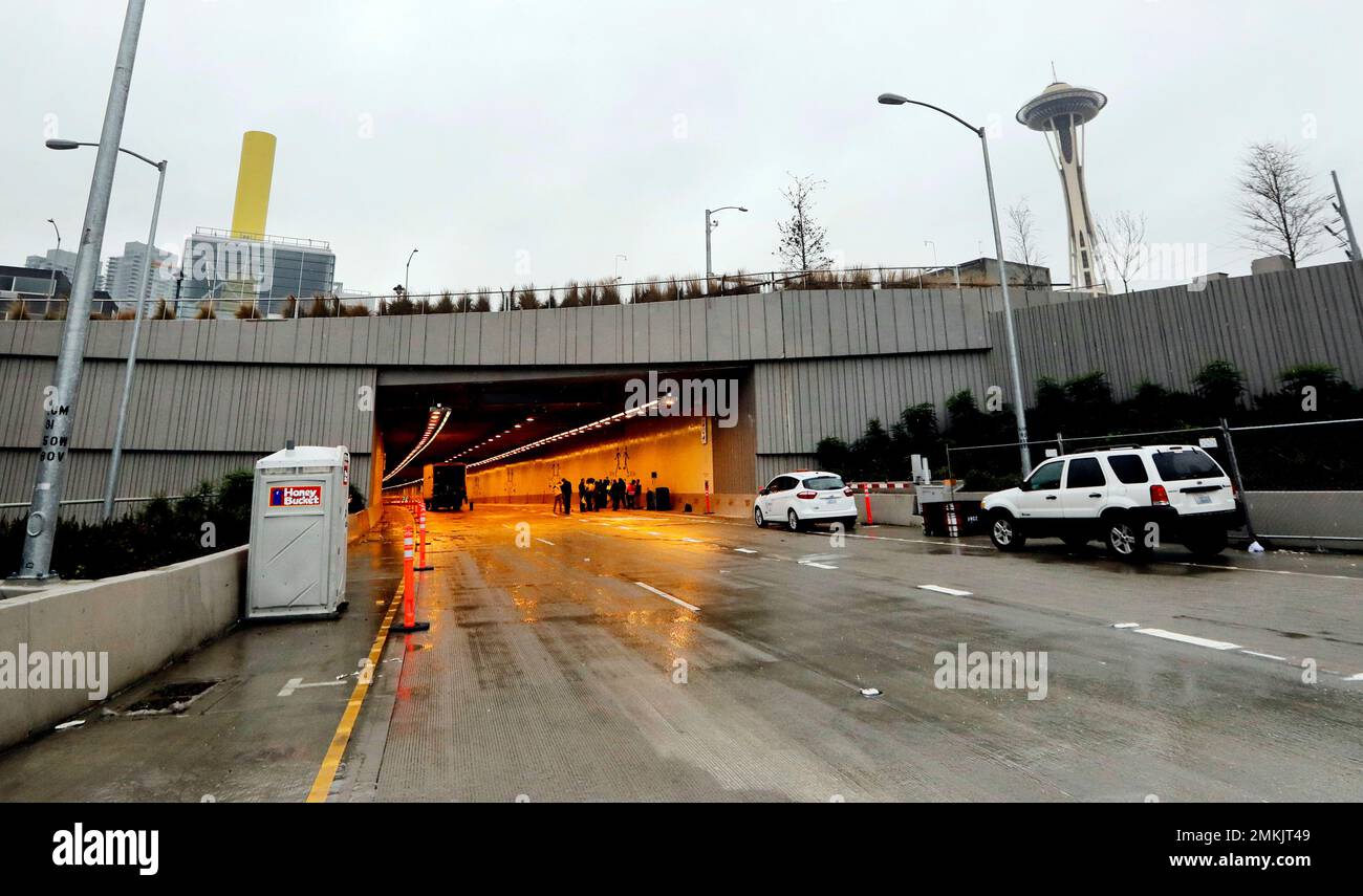 A small group gathers just inside the southbound roadway at the north ...