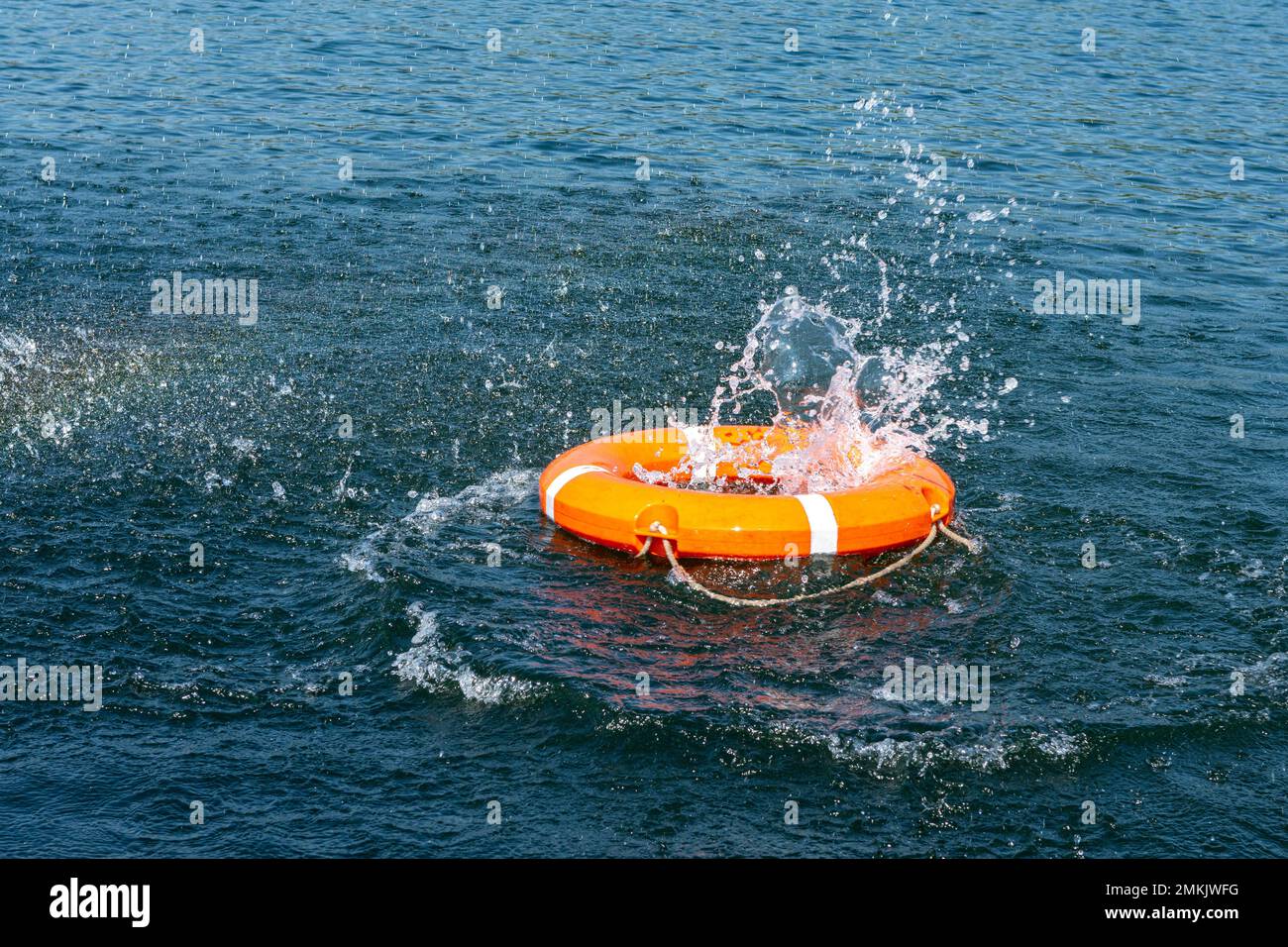 Orange lifebuoy in the sea on the water. The lifebuoy fell with a ...