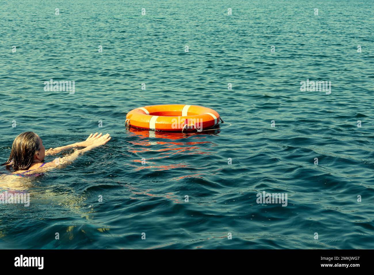 A person in the water gets a lifeline to help. The concept of saving ...