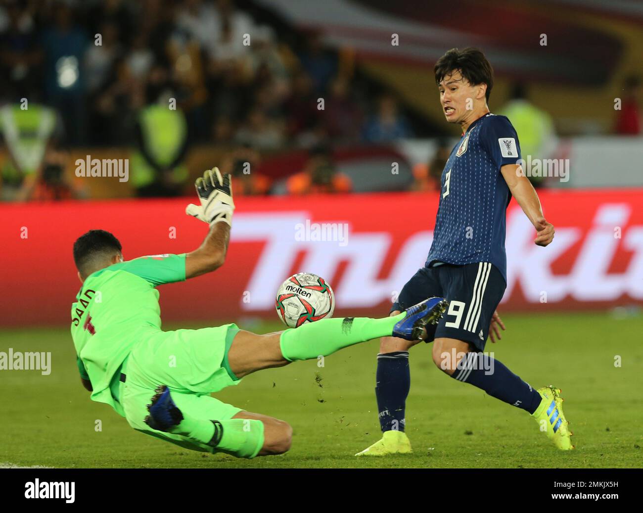 Japan's forward Takumi Minamino scores by Qatar's goalkeeper Saad Al ...
