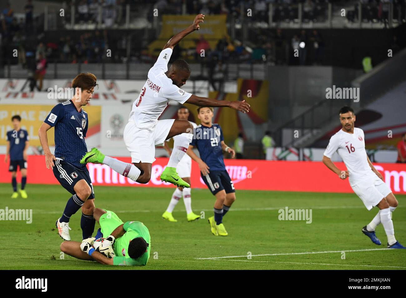 Japan's forward Yuya Osako, left, challenges Qatar's goalkeeper Saad Al ...