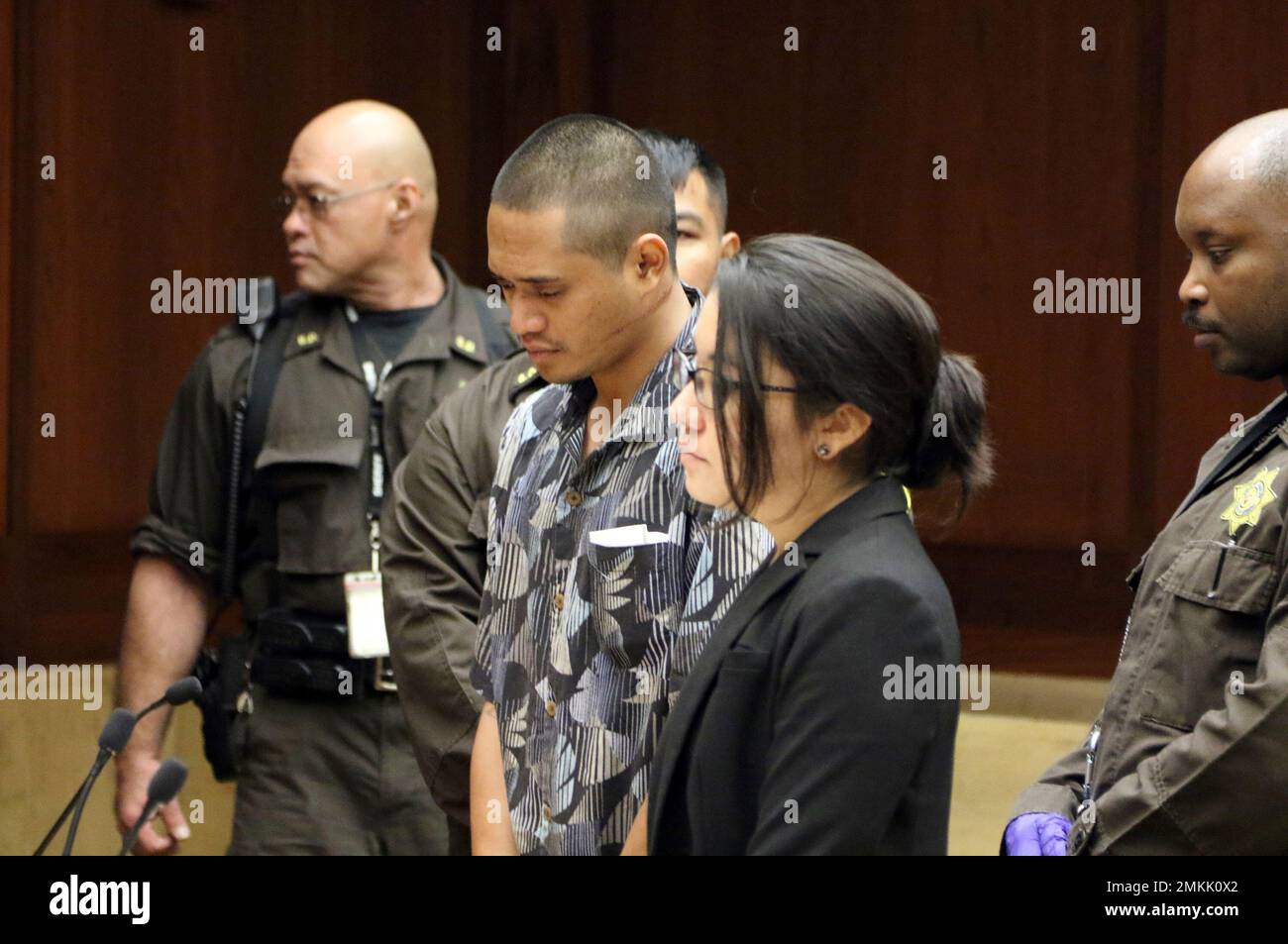 Alins Sumang stands next to Deputy Public Defender Sarah Nishioka in ...